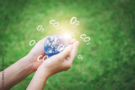Hand Holding Earth With O2 And Co2 Icon And Nature Background Energy