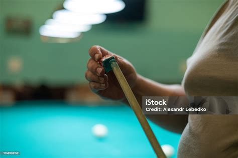 Closeup A Mans Hand Rubs The Tip Of A Billiard Cue With Chalk For A