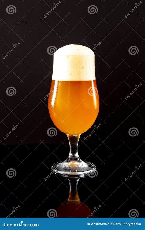 Glass Goblet With Light Lager Beer On A Glass Black Table Stock Image