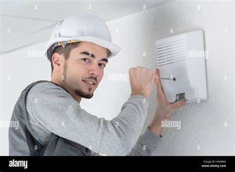 Installing A Device On The Wall Stock Photo Alamy