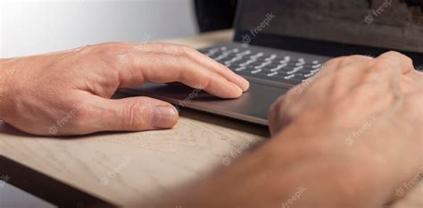Premium Photo Hand On Laptop Touchpad Tapping And Scrolling With Fingers Close Up