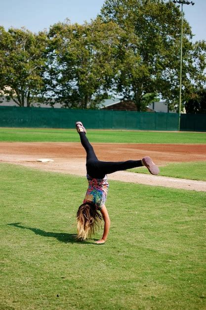 Premium Photo Girl Doing Handstand In Park