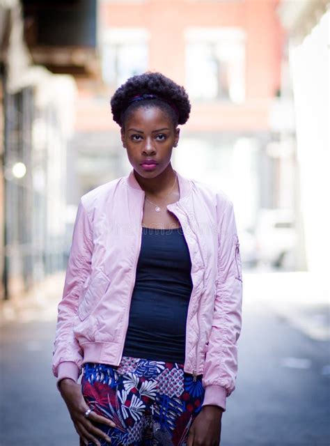 Portrait Of Fashionable Black Woman Walking On City Street And T Stock