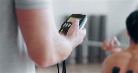 Hands With Electrical Muscle Stimulator For Physiotherapy Exercise