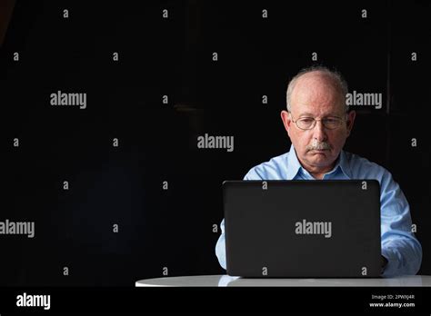 Grey Haired Senior Man With Mustache Wearing Eyeglasses And Using