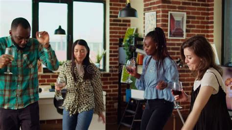 Group Of Friends Dancing At Apartment Party Having Fun Together