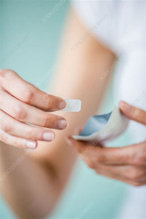 Woman Applying A Patch Stock Image C035 6985 Science Photo Library