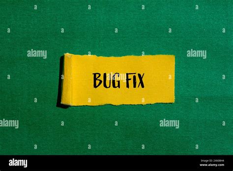 Bug Fix Words Written On Ripped Yellow Paper With Green Background