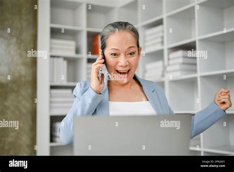 Happy And Overjoyed Senior Businesswoman Feeling Exited After Hearing A God News From The Phone