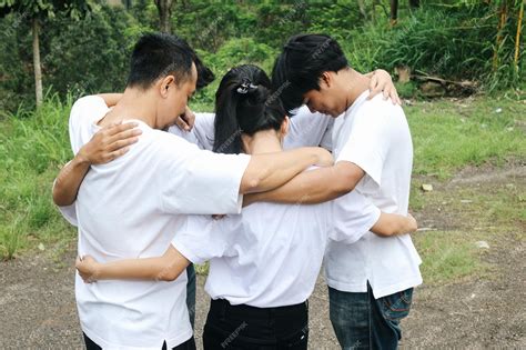 Premium Photo Group Of People Bonding In Circle And Hug Each Other