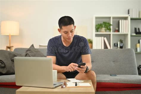 Handsome Asian Man Calculating Monthly Expenses And Managing Household