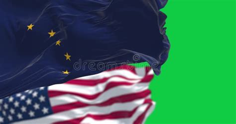 Alaska State Flag Waving In The Wind Behind The National Flag Of The Us