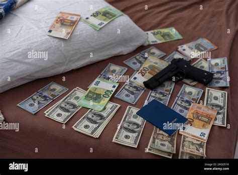 Money And Weapons In Crime Lab For Investigation Conceptual Image