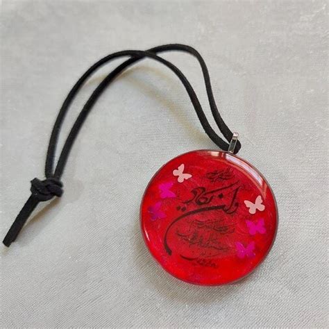 خرید و قیمت آویز ماشین رزینی مزین به وان یکاد و حرز امام جوادع ترب