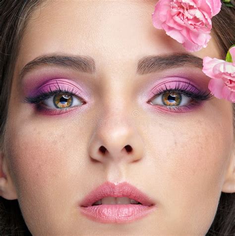 Closeup Portrait Of Female Face With Pink Beauty Makeup And Carnation