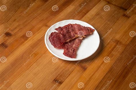 Beef Bacon Slice Served In Plate Isolated On Wooden Table Top View Of