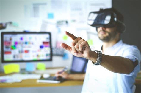Young Male Software Programmer Testing A New App With 3d Virtual Reality Glasses In Office Stock