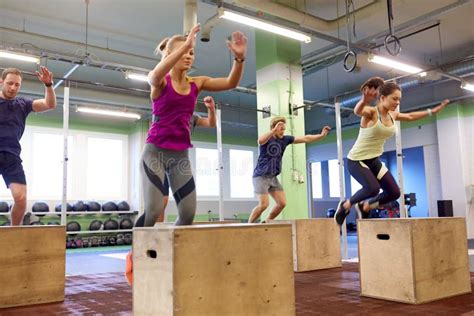 Group Of People Doing Box Jumps Exercise In Gym Stock Image Image Of