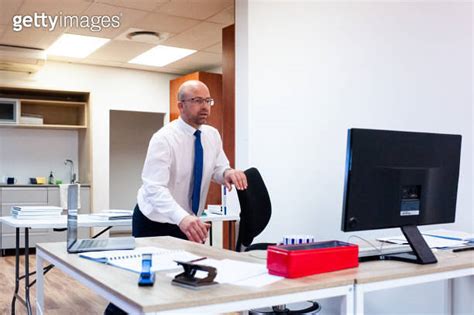 Goofy Office Employee Standing Looking At Screen As His Hand Slips And