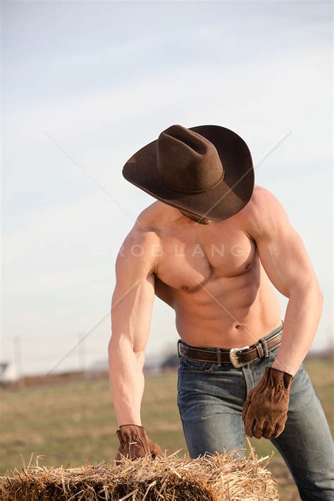Hot Muscular Cowboy Lifting Bales Of Hay On A Ranch Rob Lang Images