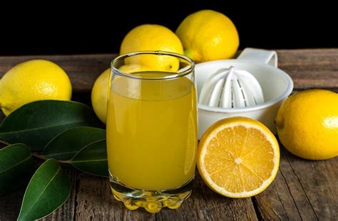 Premium Photo | Squeezing lemon juice with hand juicer