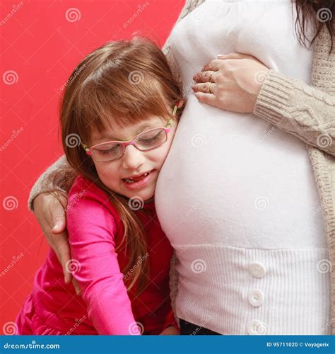 Hija Que Abraza A Su Madre Embarazada Foto De Archivo Imagen De