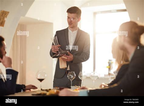 Portrait Of Professional Sommelier Presenting Wine During Wine Tasting