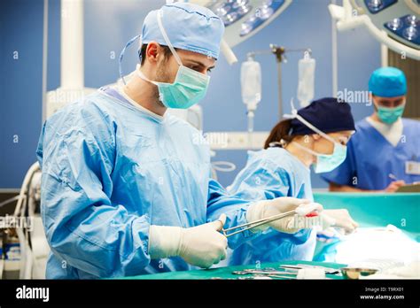 Surgeon Using Medical Scissors While An Operation Stock Photo Alamy