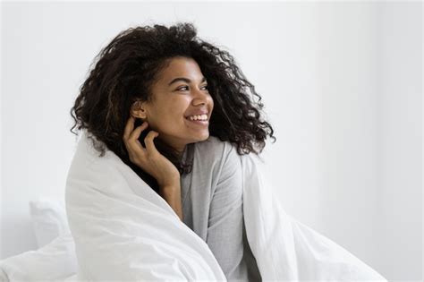 Premium Photo Happy Dark Skinned Woman Wrapped In A Blanket