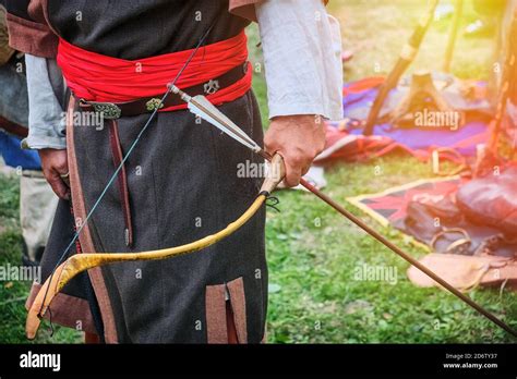 Archer In National Dress With A Bow And Arrow In His Hands Hunter Tribes On The Warm Summer Day
