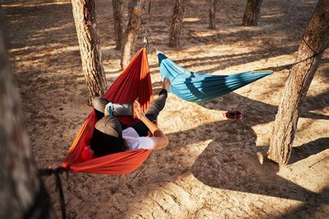 Premium Photo Man Lying On Hammock At Beach