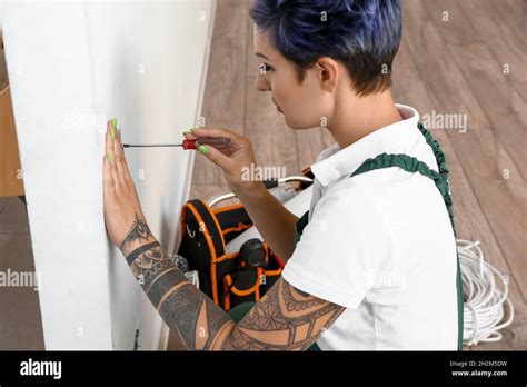 Female Electrician Repairing Socket In Room Stock Photo Alamy