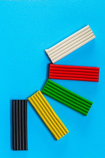 Premium Photo A Group Of Different Colored Sticks On A Blue Surface
