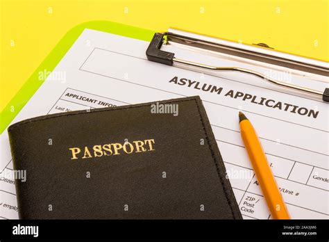 Asylum Concept Showing An Application Form For Asylum On A Yellow