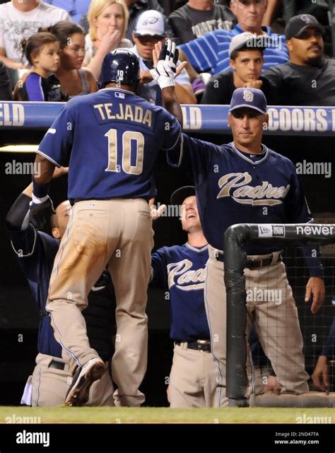 San Diego Padres' Miguel Tejada (10) is congratulated by manager Bud Black after scoring against ...