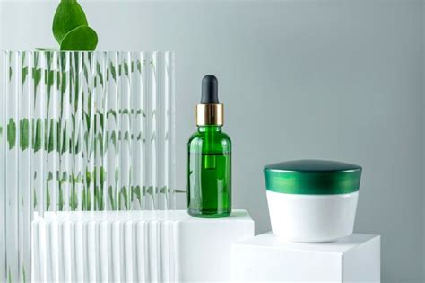 Premium Photo Antiaging Collagen Facial Serum In Green Glass Bottle And Face Cream On White