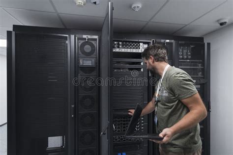 data center engineer usaing keyboard on a supercomputer server room