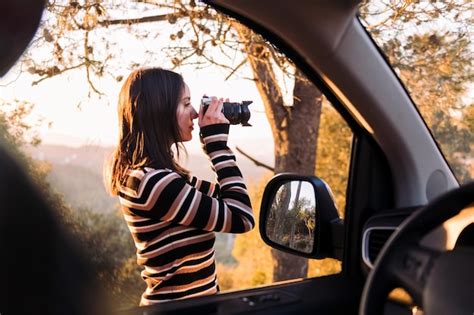 Premium Photo Woman Taking Photos Of Nature During A Road Trip