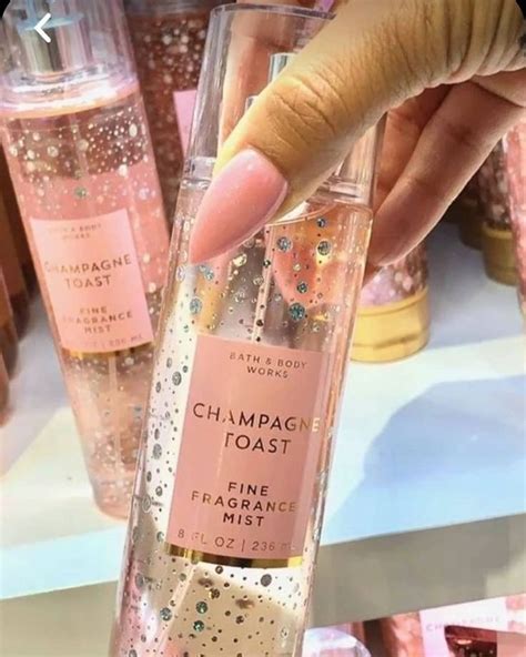 A Person Holding Up A Bottle Of Champagne In Front Of Other Bottles