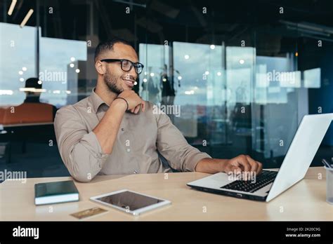 Happy And Successful Indian Man Working In Modern Office Building Programmer In Glasses Using