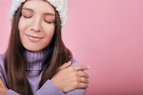 Smiling Calm Woman Hugs Her Shoulders Warms Herself Because She Is