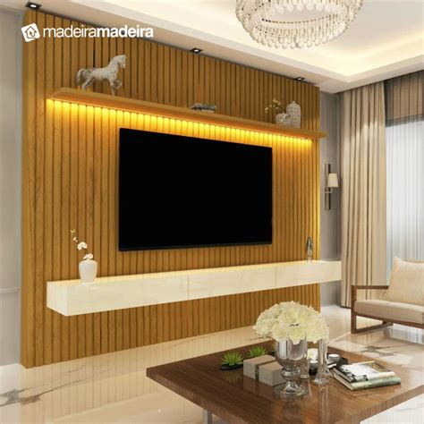 A Living Room With A Large Flat Screen Tv Mounted To The Side Of A Wall