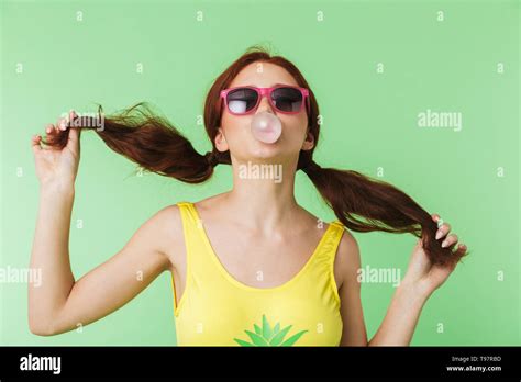 Image Of A Beautiful Young Redhead Girl Posing Isolated Over Green Wall
