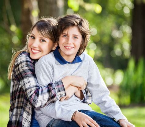 Happy Mother Embracing Son At Campsite Stock Photo Image Of Focus