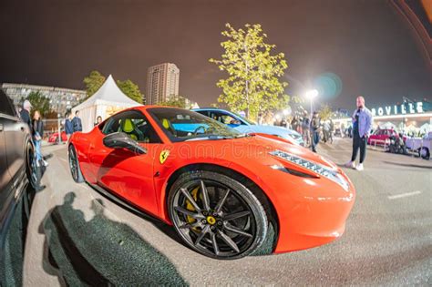Night Scene With A Gleaming Orange Ferrari Sports Car In A Large