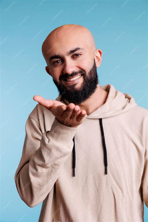 Premium Photo Smiling Arab Man Blowing Air Kiss While Looking At