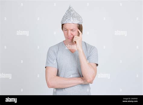 Stressed Young Man With Tinfoil Hat As Conspiracy Theory Concept