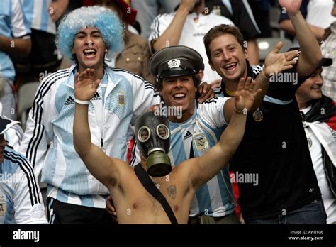 A Male Argentinian Football Fan Wearing A Gas Mask Cheers From The