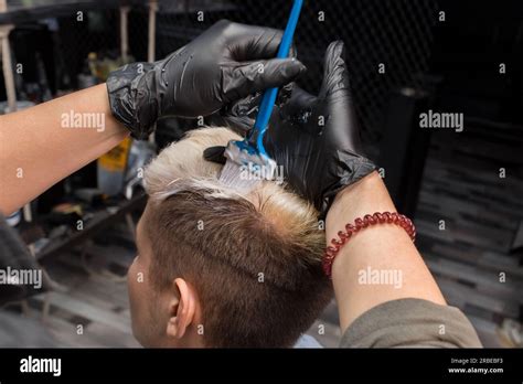 The Hands Of A Professional Barber Girl In Gloves Dye Hair Roots White