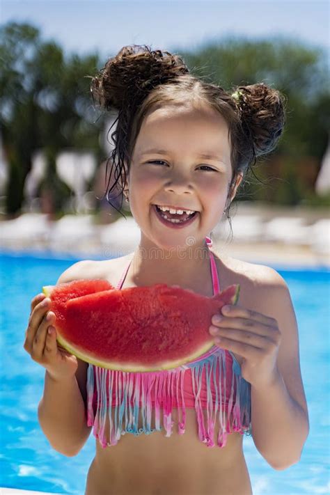 A Girl In A Swimsuit Stands With A Watermelon On The Beach Stock Image